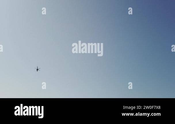 Military helicopter on battlefield flies overhead passing in slow ...