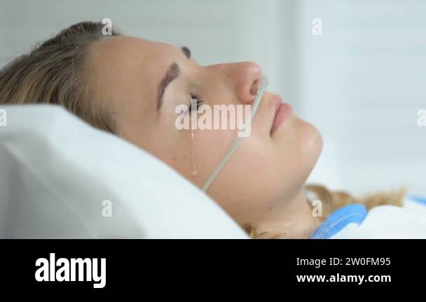 Sad crying woman with nasal cannula lying hospital bed, disease ...