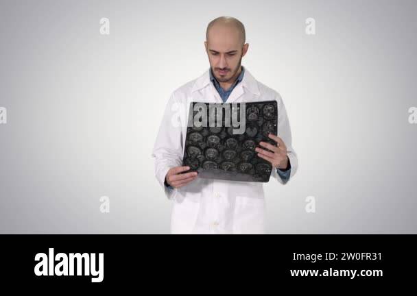 Arabian physician reviewing a MRI brain scan while walking on gradient ...