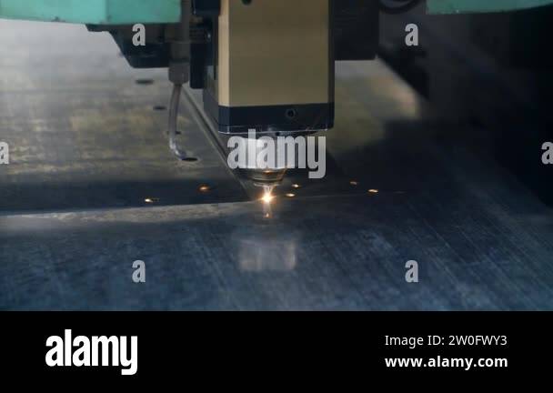 Laser beam cutting rectangular hole in metal sheet according to ...
