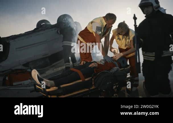 On the Car Crash Traffic Accident Scene: Paramedics Saving Life of a ...
