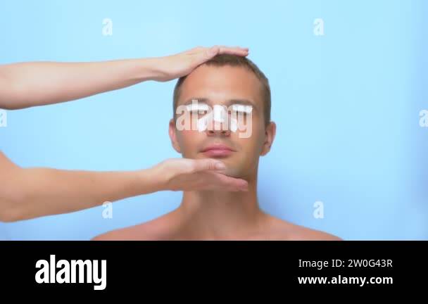 Plastic surgery concept, hands holding a mans face. a man after a ...