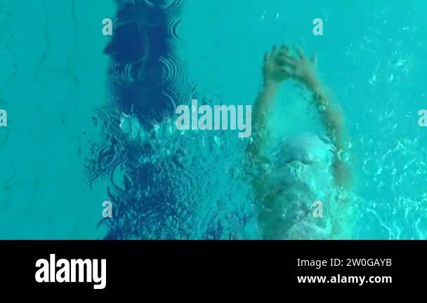 Girl Swimmer Dive In Swimming Pool. Female swimmer dives in swimming ...