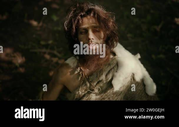 Portrait of Primeval Caveman Wearing Animal Skin Raises Hands to Heaven ...