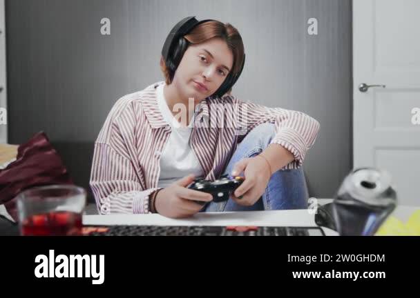 Boring Young Gamer Girl playing in Video Games on a Console with a ...