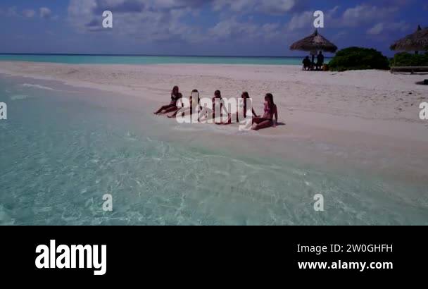 video the tan girls in bikini lying on the white sandy beach and ...