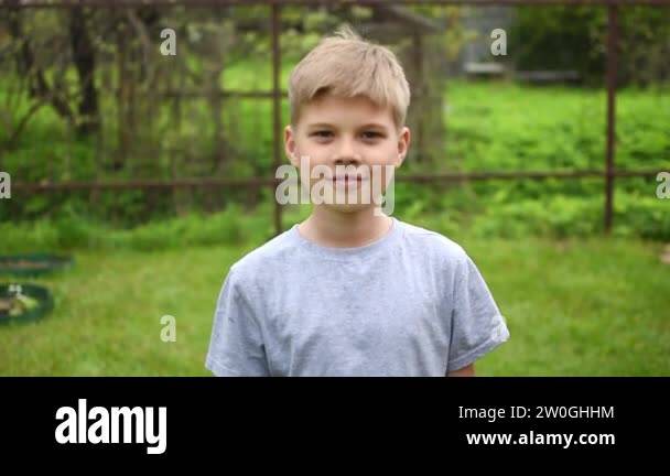 child boy with a gun is aiming at outdoor target. Learning to shoot a ...