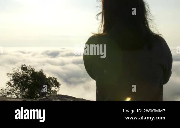 Rear view of woman photographer is taking images with dslr camera in ...