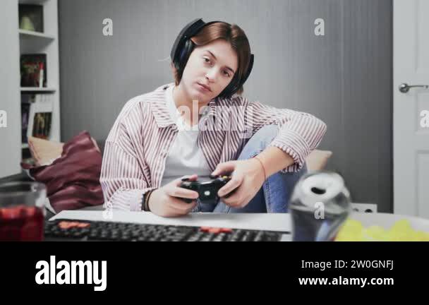 Boring Young Gamer Girl playing in Video Games on a Console with a ...