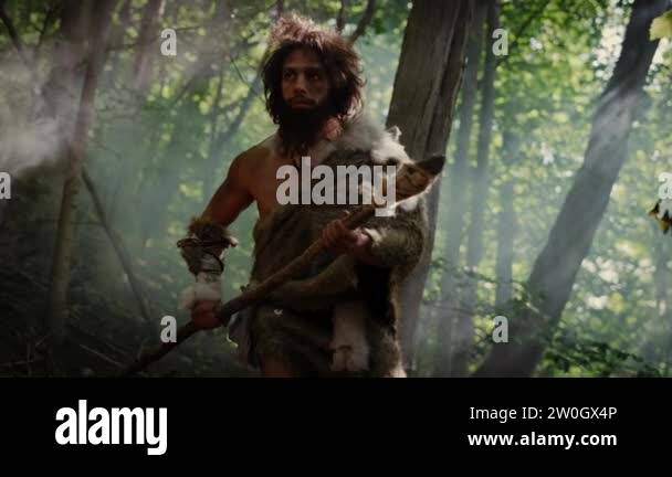 Portrait of Primeval Caveman Wearing Animal Skin and Fur Hunting with a ...