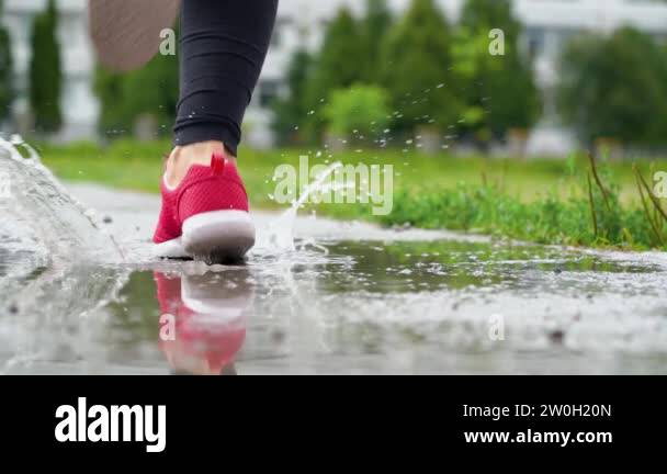Legs of a runner in sneakers. Sports woman jogging outdoors, stepping ...