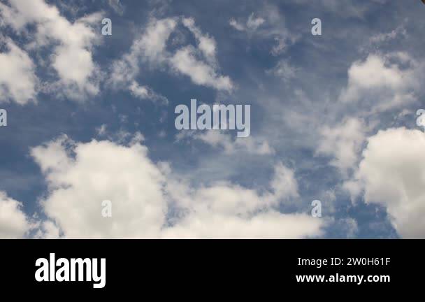 Clear blue sky with cumulus clouds that stand still and cirrus clouds ...