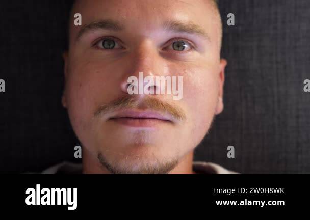 Close-up view of man who applying eye drop medicine healing. Young guy ...