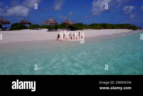 video the tan girls in bikini lying on the white sandy beach and ...