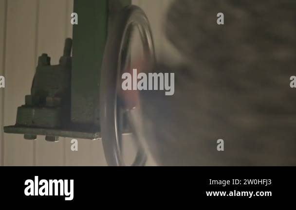 Close-up of hands A male researcher rotates the manual wheel of the ...