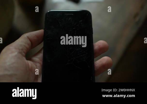 Concept of smart phone with broken screen. Top view of man hands ...