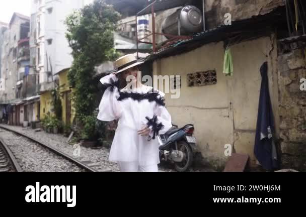 Beautiful and young fashion mestizo girl walking along the asian street ...