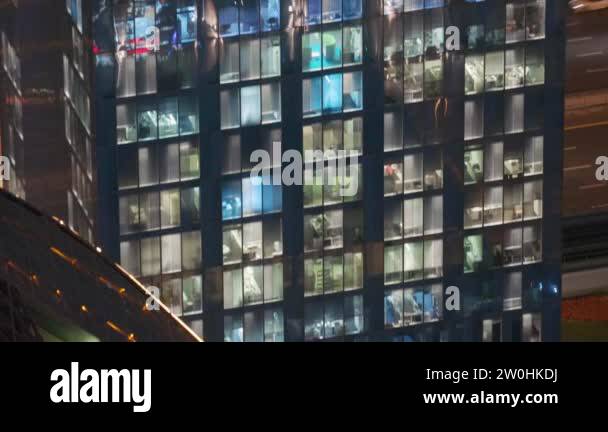 Night view of exterior apartment tower. High rise skyscraper with ...