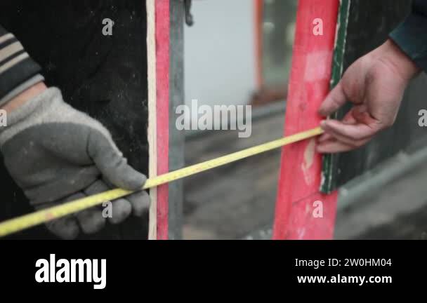 Mens Hands Measure Distance Of Gap Between Wooden Boards Using A Meter ...