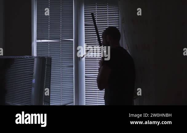 man with gun, looking through the window. bodyguard and self defense ...