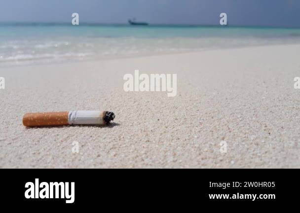 Cigarette on the beach, smoking concept. Summertime paradise in ...