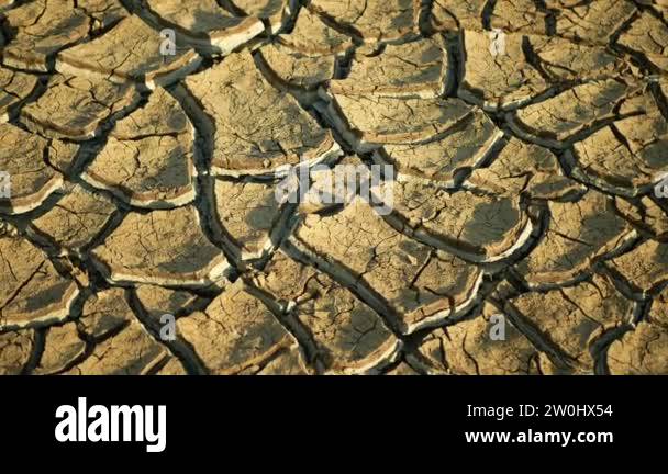 Drought cracked lake pond wetland clay drying up the soil crust earth ...