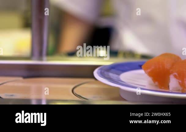 Slow motion of sushi on moving conveyor belt in a Japan restaurant ...
