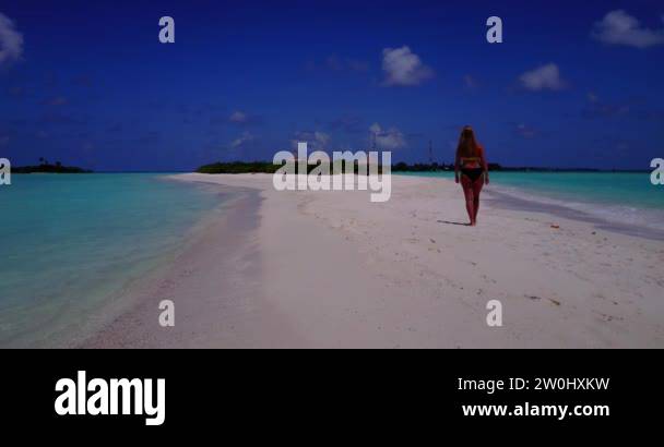 video the tan girl in bikini walking on sea scythe thinking about ...
