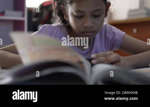 Little cute asian girl using and watching video from mobile phone on ...