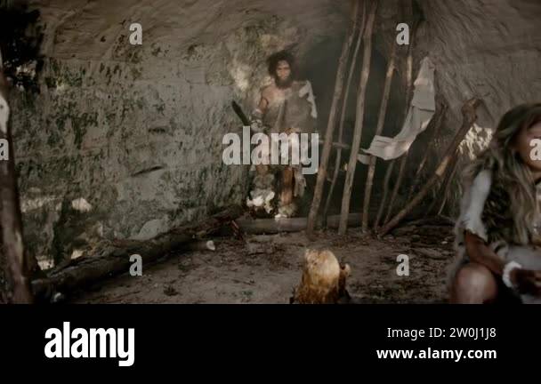 Tribe Leader Wearing Animal Skin Walks out of the Cave Looks at Family ...