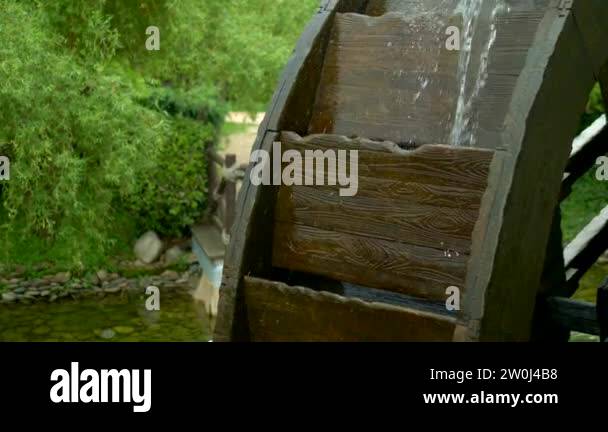 water Mill. close-up. the details. the wooden wheel of the mill rotates ...