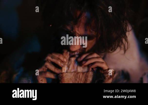 Portrait of Tribe Leader Wearing Animal Skin Eating in a Dark Scary ...