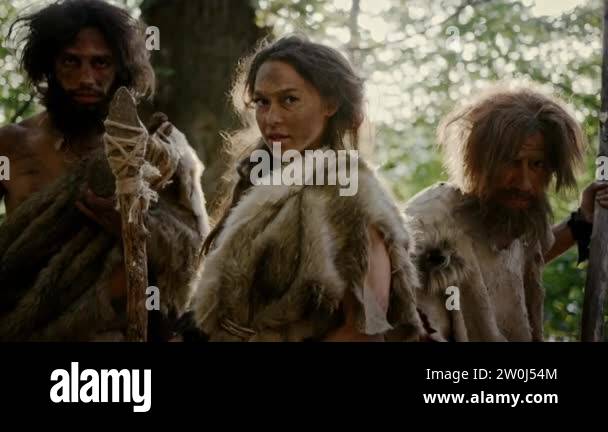 Female Leader and Two Primeval Cavemen Wearing Animal Skins Attack ...
