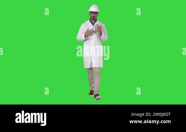 Scientist in white robe and helmet presenting pointing to side with ...