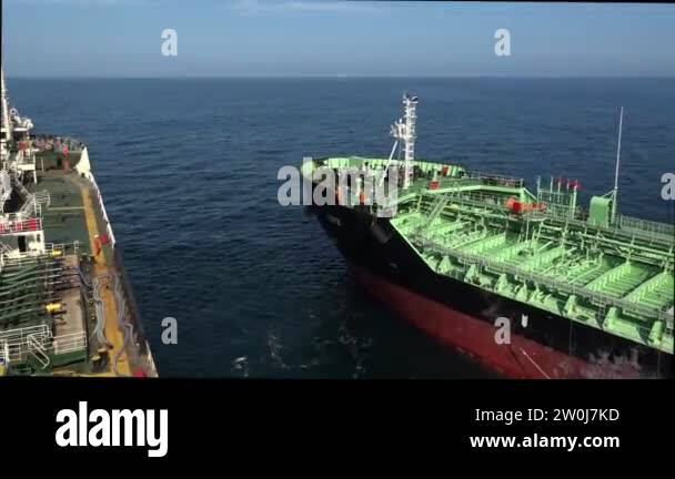 modern oil tanker with professionals moors to bulk carrier Stock Video ...