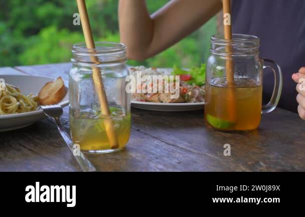 Young woman and her little son have a lanch in a cafe with an epic view ...