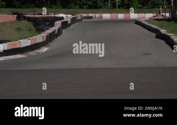 Young racer at go-kart racetrack circuit championship crossing the ...