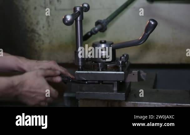 Lathe in action. Old lathe in the lathe shop.The operator of the ...