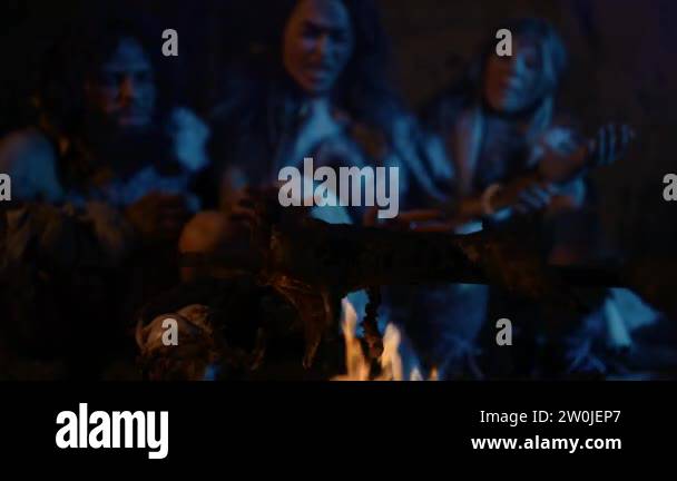 Neanderthal or Homo Sapiens Family Cooking Animal Meat over Bonfire and ...