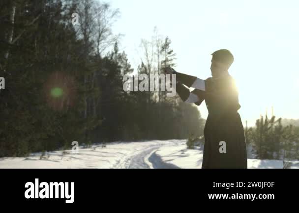 Young man in national clothes holding a sword, standing in front of ...