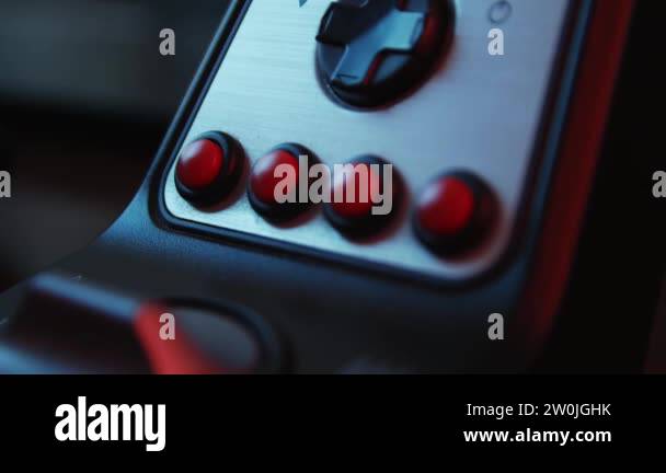 Close-up of the hands of a young gamer behind the steering wheel of a ...