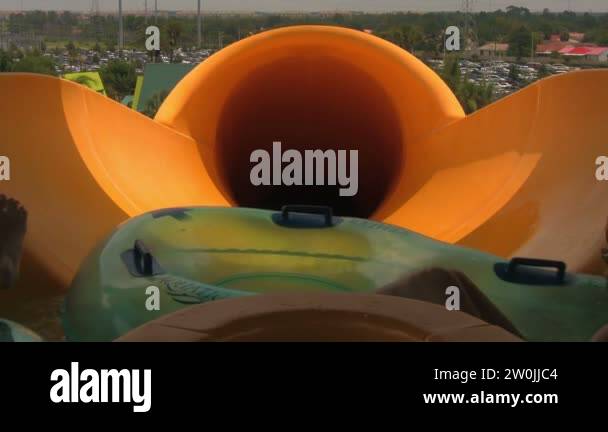 A Lady Sitting on an Inflatable Tube Starting the Water Slide Ride at ...