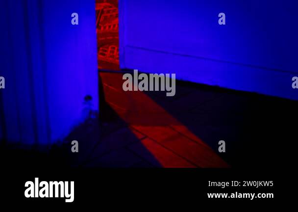 Red light flickers in an empty room. Crime scene. Fear of loneliness ...