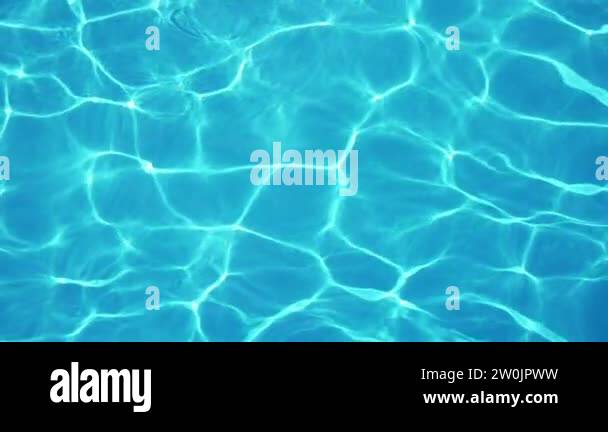 Turquoise waves with playful beams rippling in a wading pool in slo-mo ...
