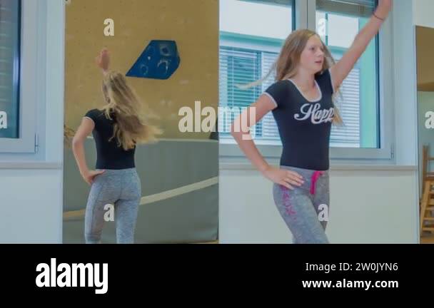 Two girls are making a turn when practising dance moves. They're ...