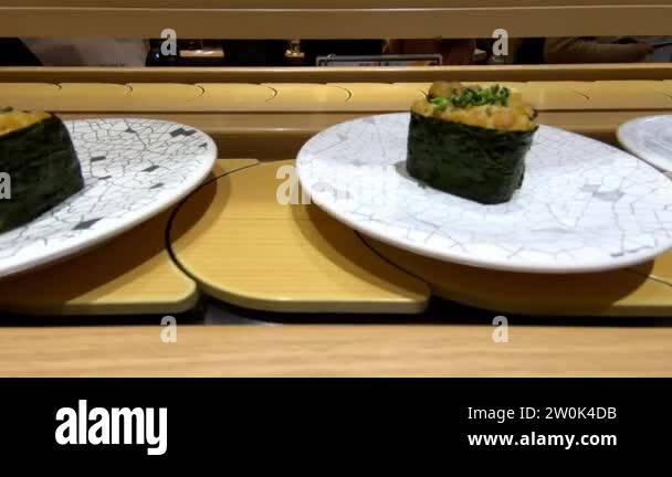 4K, Sushi on moving conveyor belt in a Japan restaurant. Traditional ...