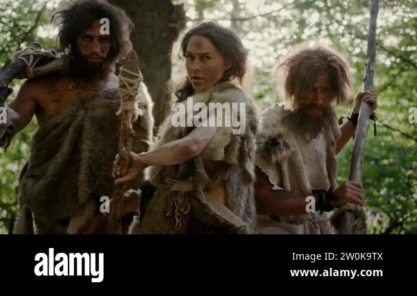 Female Leader and Two Primeval Cavemen Wearing Animal Skins Threat ...