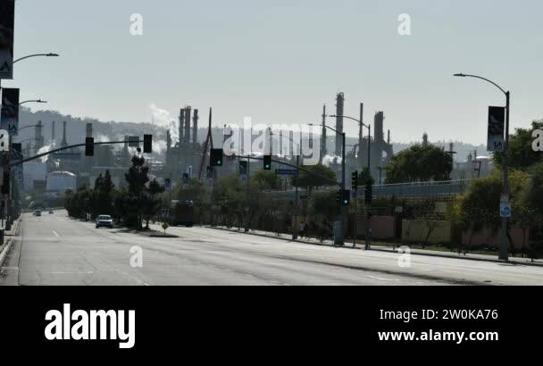 Air pollution rising from smoke stacks at an oil refinery and factories ...