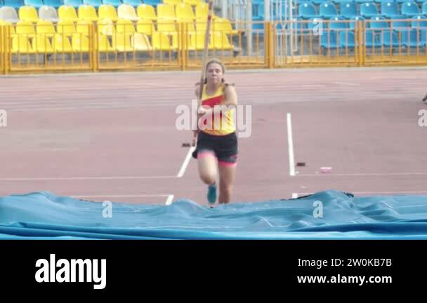 KAZAN, RUSSIA 26-07-2019: a young woman jumping over the bar with an ...