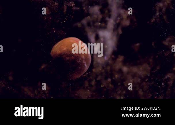 Planet in the space, one of its sides is shaded. Transparent nebula is ...